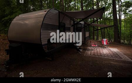 Campter trailer at Jordan Lake at night with both awnings out and ...