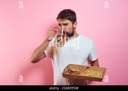 Cheerful man mug of beer fast food diet food lifestyle blue background ...