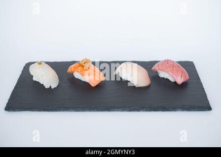 High angle view of delicious sushi served in trays with drinking ...