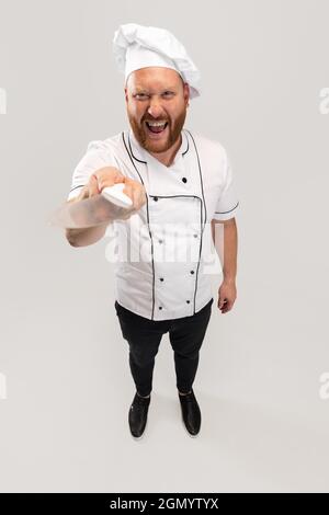 High angle view of hadsome bearded man, cook, male chef in white ...