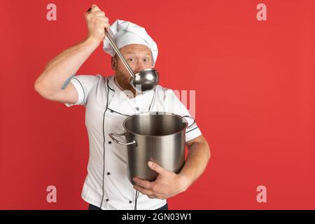 Comic portrait of hadsome bearded man, cook, male chef in white uniform ...