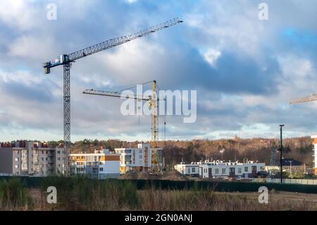 Multi-storey scaffolding structure with company logos on a sunny ...