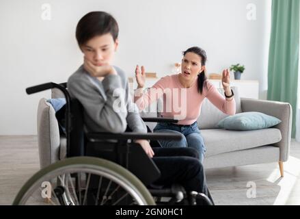 Disabled woman in wheelchair screaming and crying in front of couple ...