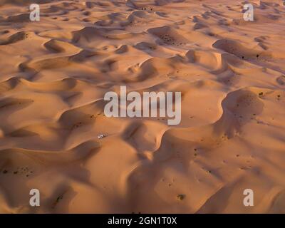 Aerial view of Arabian Nights Village desert resort amid dunes at ...