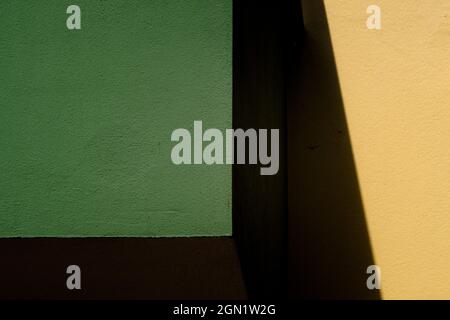 Closeup of the sharp angles of a building, yellow and green colored ...