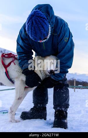 Man cuddling with his dog in winter Stock Photo - Alamy