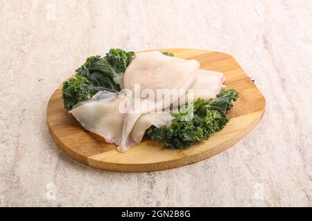 Raw squid over wooden board for cooking Stock Photo - Alamy