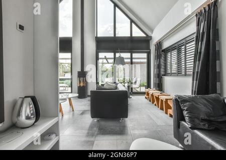 Interior of stylish spacious gray colored living room furnished with ...