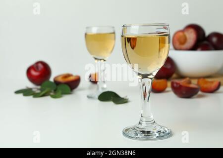 Plum vodka shots and ingredients on white background Stock Photo - Alamy