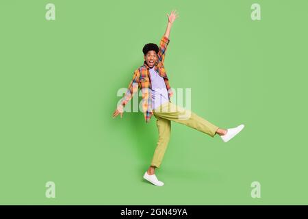 Photo of pretty funky dark skin guy dressed checkered shirt showing v ...