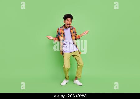 Photo of impressed funny dark skin guy dressed sport outfit big eyes ...
