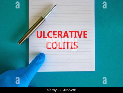 Ulcerative colitis symbol. White note with words Ulcerative colitis ...