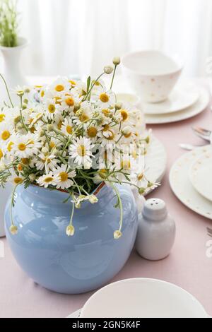 Stylish table setting with beautiful chamomile flowers on grunge ...