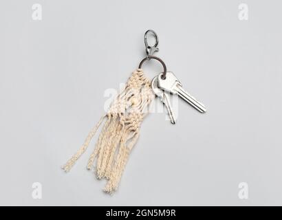 Keys with handmade cotton keychain on white background Stock Photo - Alamy