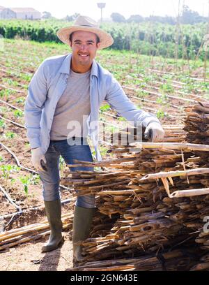 Portrait of positive hired worker on farm field on day Stock Photo - Alamy