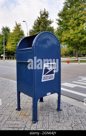 United States Postal Service mailbox on a busy street with a UPS truck ...