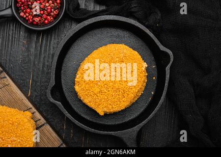 Frozen Breaded fish patties set, on black dark stone table background ...