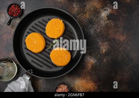 Frozen Breaded fish patties set, on black dark stone table background ...