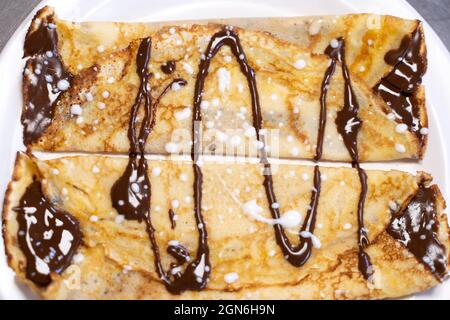Aerial close up view of a pancake with chocolate on top served on a ...