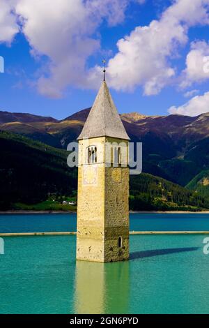 Only the lone bell tower church shoots up from the water of the lake in ...