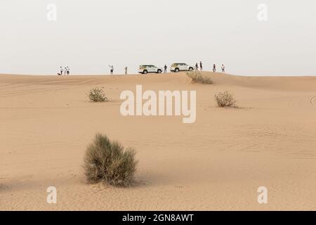 United Arab Emirates, Dubai, Lahbab Desert, woman walking in desert ...