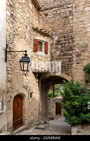 Crestet narrow street of typical provencal old town, medieval village ...