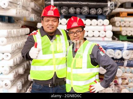 two happy Factory workers with thumb up Stock Photo - Alamy