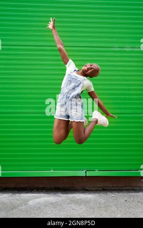 Excited millennials jumping in the air on studio backgrounds Stock ...