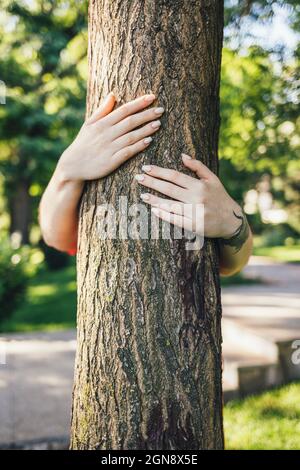 Woman's hands on a tree trunk Stock Photo - Alamy