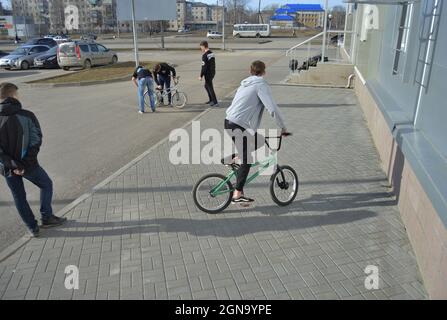 Kovrov, Russia. 9 April 2017. Teens who ride on BMX bikes resting and looks at ride friends on ...