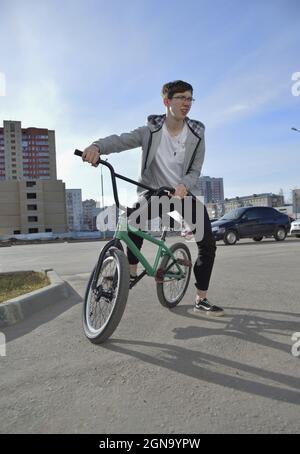Kovrov, Russia. 9 April 2017. Teen on BMX bike performs a trick near the shopping center Rus ...