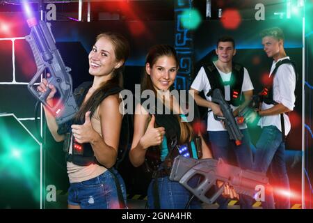 Two girls posing with laser guns Stock Photo - Alamy