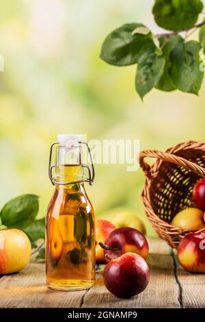 Top view cidre bottle on and ripe apples rustic wooden table. Glass and ...