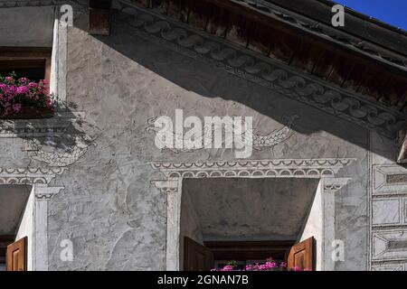 house front in Scuol in the traditional Engadine architecture style ...