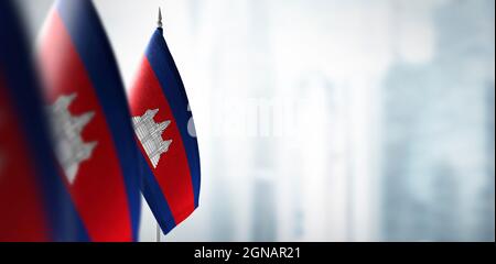 Small flags of the Cambodia on an abstract blurry background Stock ...