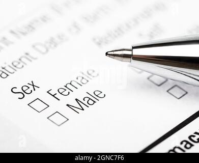 Pen over male female gender option checkboxes in a document form Stock ...