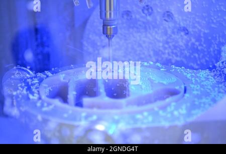 Dental milling machine carving out shape of human teeth Stock Photo - Alamy