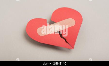 High angle broken heart with band aid Stock Photo - Alamy