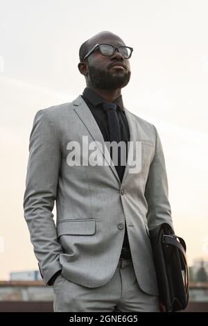 Low angle shot of a handsome bearded man choosing lighting for his ...