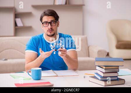Young student physicist studying molecular model at home Stock Photo ...