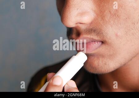 Man applying lip balm Stock Photo - Alamy