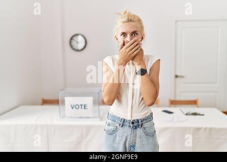 Beautiful caucasian woman standing by voting ballot at election room ...