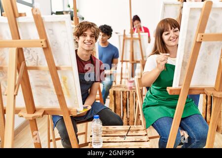 Group of young draw students smiling happy standing with hands together ...