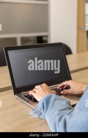 Concept of modern working style. Hand holding smartphone and other one ...