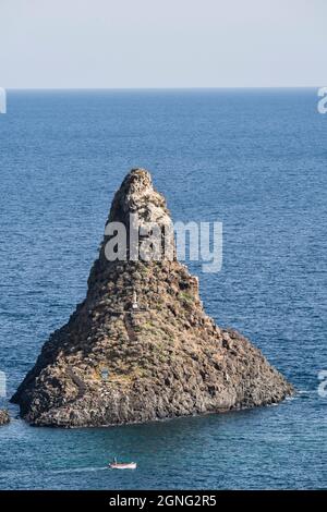 The Faraglioni, a group of volcanic basalt sea stacks off Aci Trezza ...
