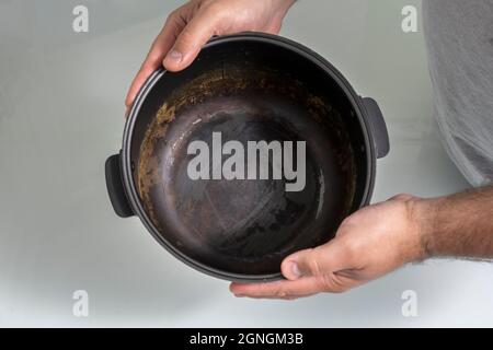 just smell it. man holding frying pan.. male chef kitchener cooking ...