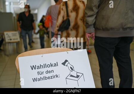 Voters line up at a polling station during general elections in ...