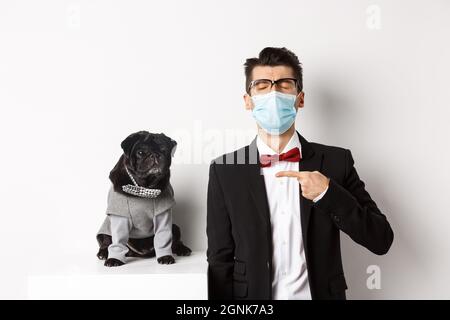 Coronavirus, pets and celebration concept. Disappointed young man in ...