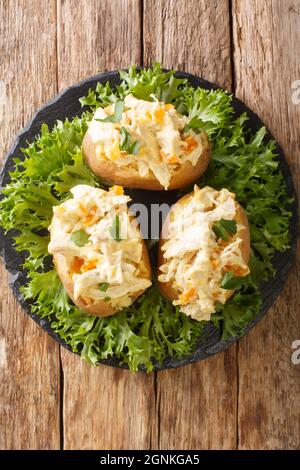 Baked potatoes stuffed with coronation chicken salad close-up on a ...