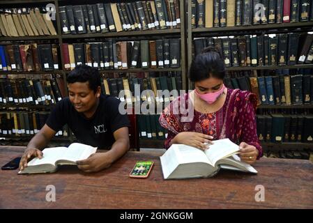 Students reads book in the central library of Dhaka University after ...